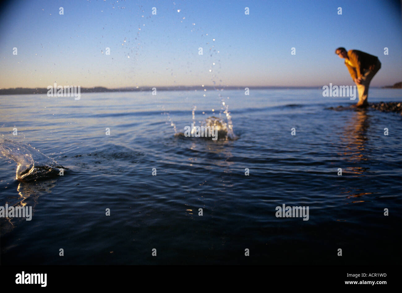 Man throwing stones hi-res stock photography and images - Alamy