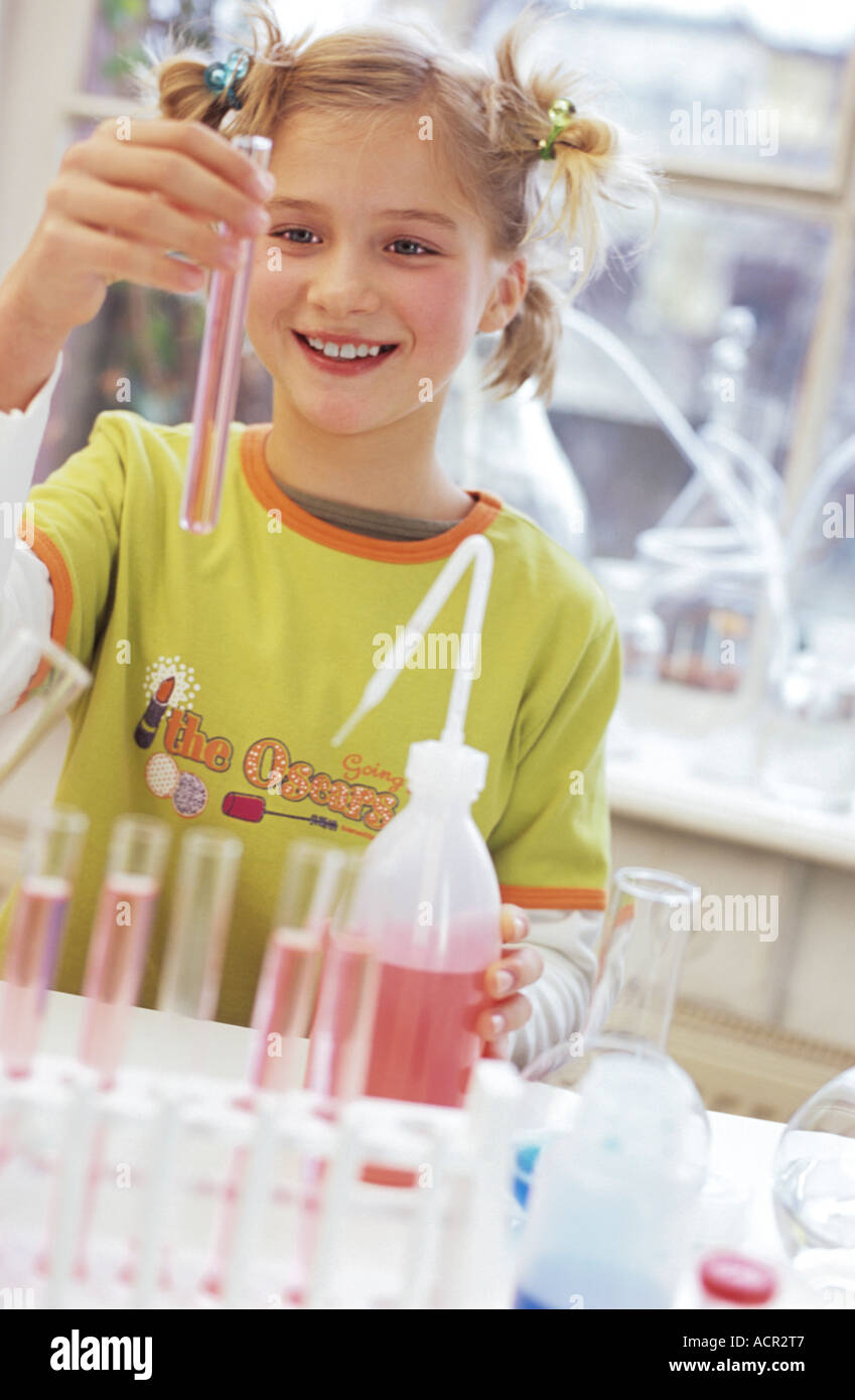 Girl (8-9) holding test tube in chemical lab, smiling Stock Photo - Alamy