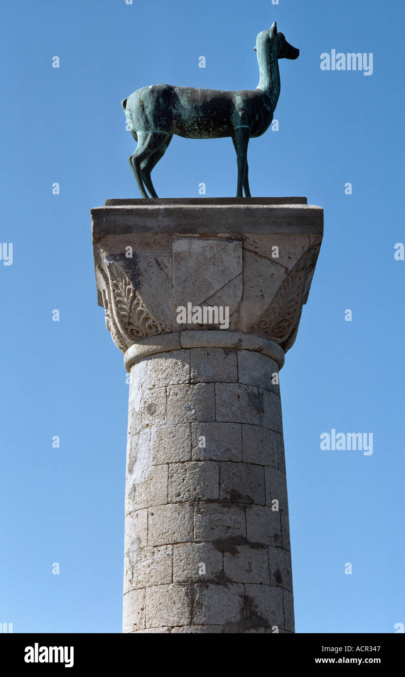 bronze statue on a column marking the location of the ancient wonder of ...