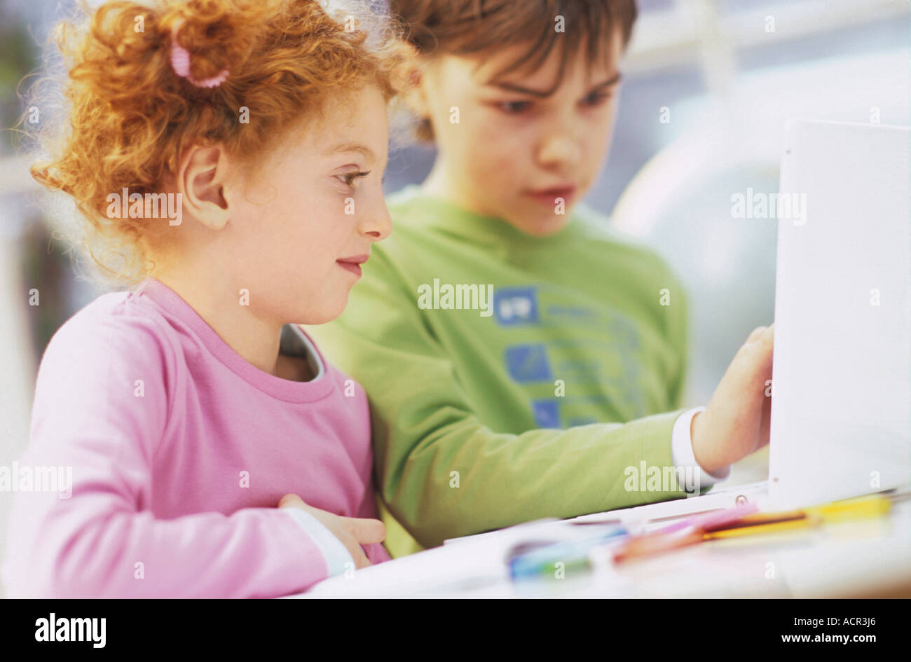 Boy and girl (7-9) using laptop Stock Photo - Alamy