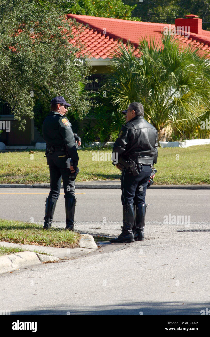 Rear View of Two Police Officers on a Street Corner Stock Photo - Alamy