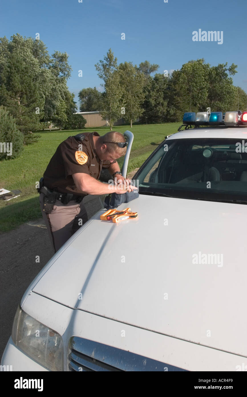 Traffic accident Sheriff s deputy searches through the belongings of an ...