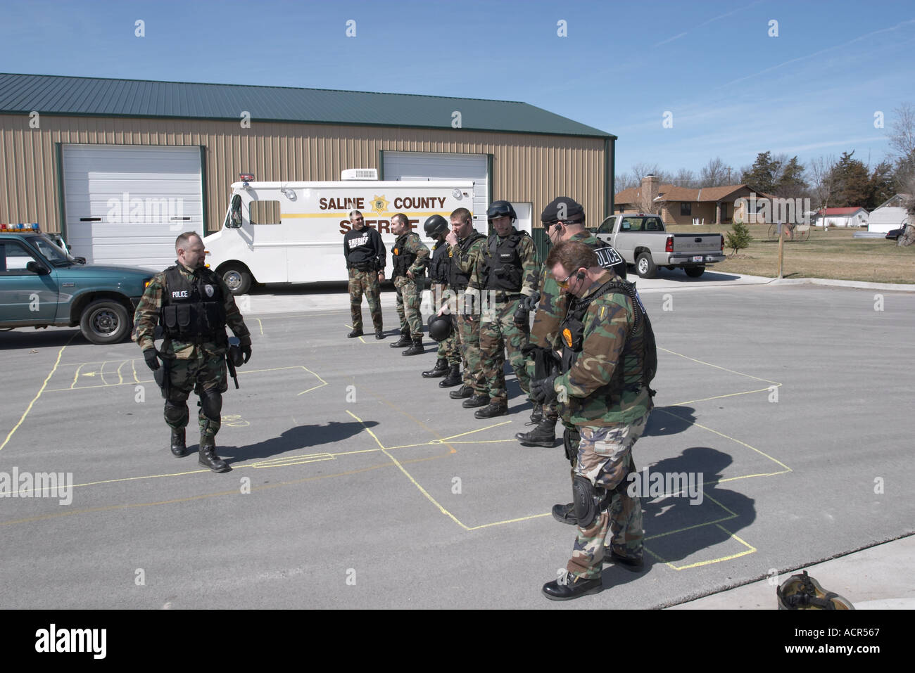 SWAT officers lined up before serving search warrant Stock Photo - Alamy