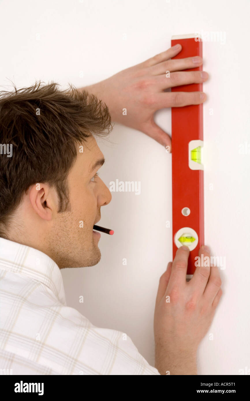Young man with red water-level Stock Photo - Alamy