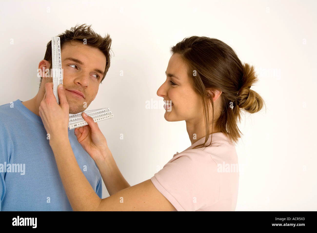 Woman measuring mans face ruler hi-res stock photography and images - Alamy