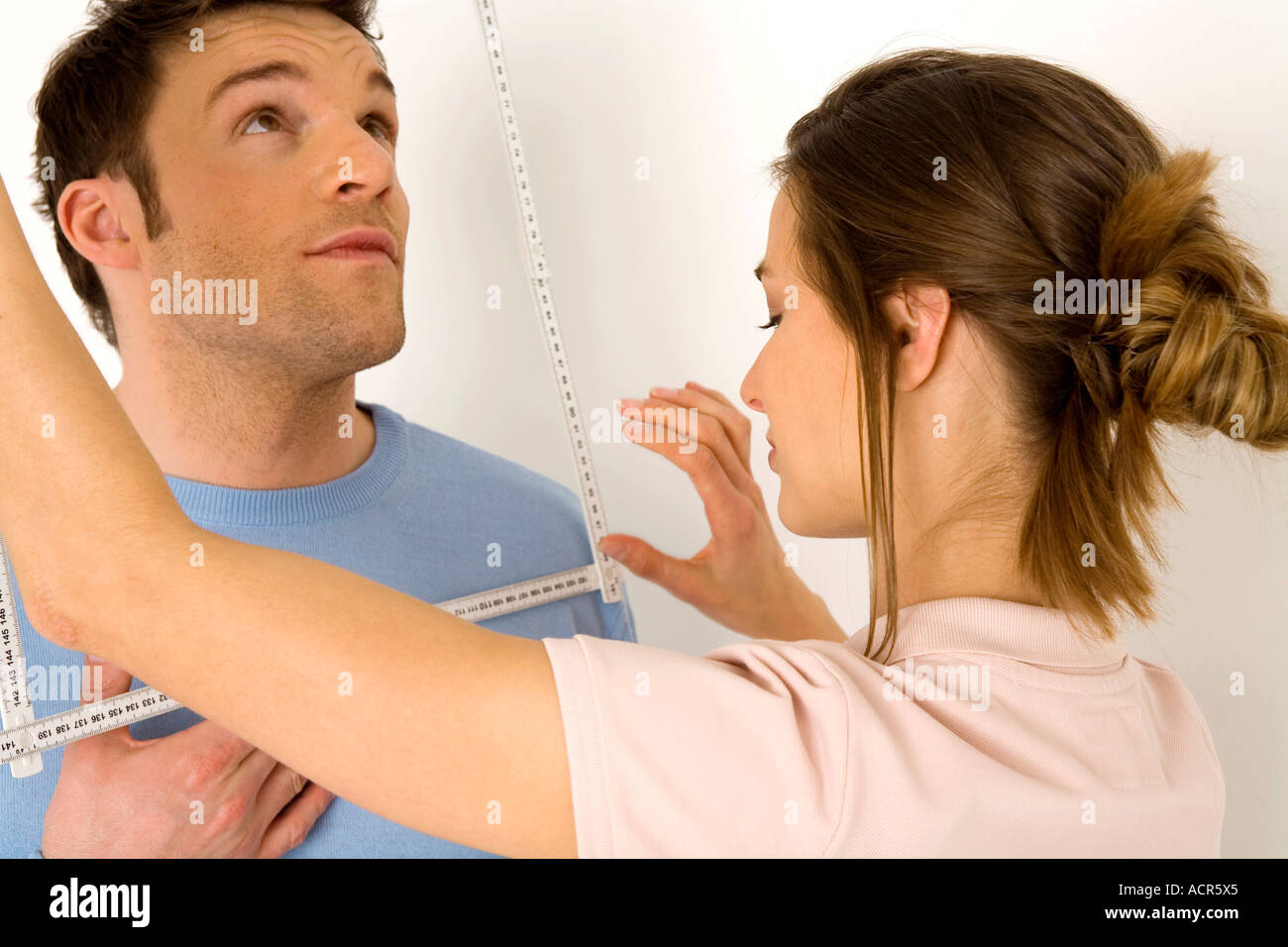 Woman measuring mans face ruler hi-res stock photography and images - Alamy
