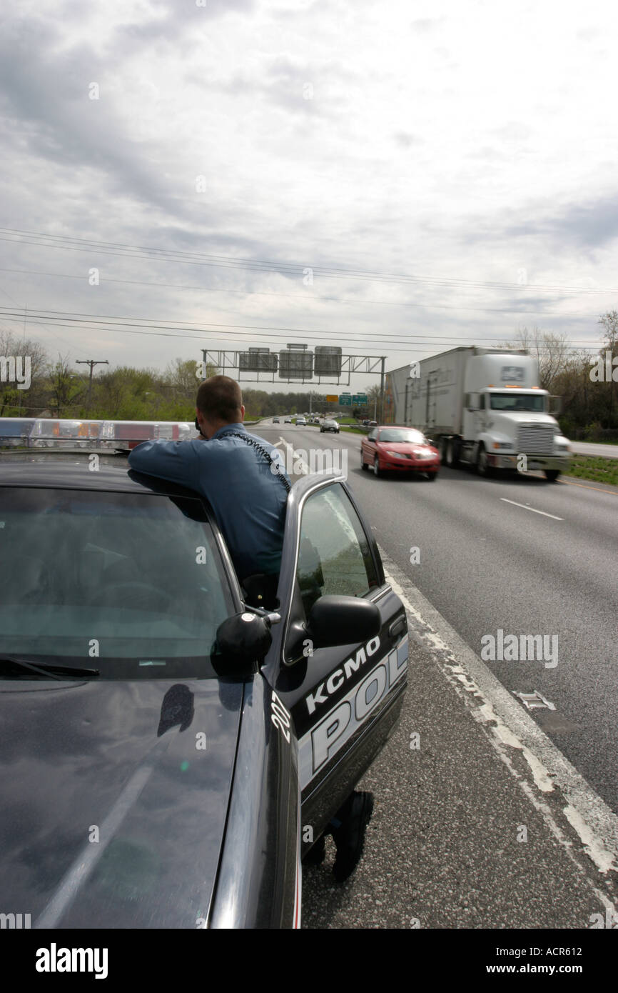 Police officer using hand-held laser to measure the speed of oncoming ...