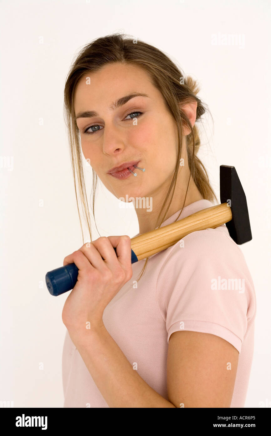 Young woman holding hammer, close-up, portrait Stock Photo - Alamy