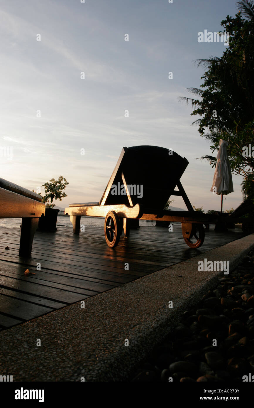 A teak sun bed on a deck in the early morning in Thailand Stock Photo ...
