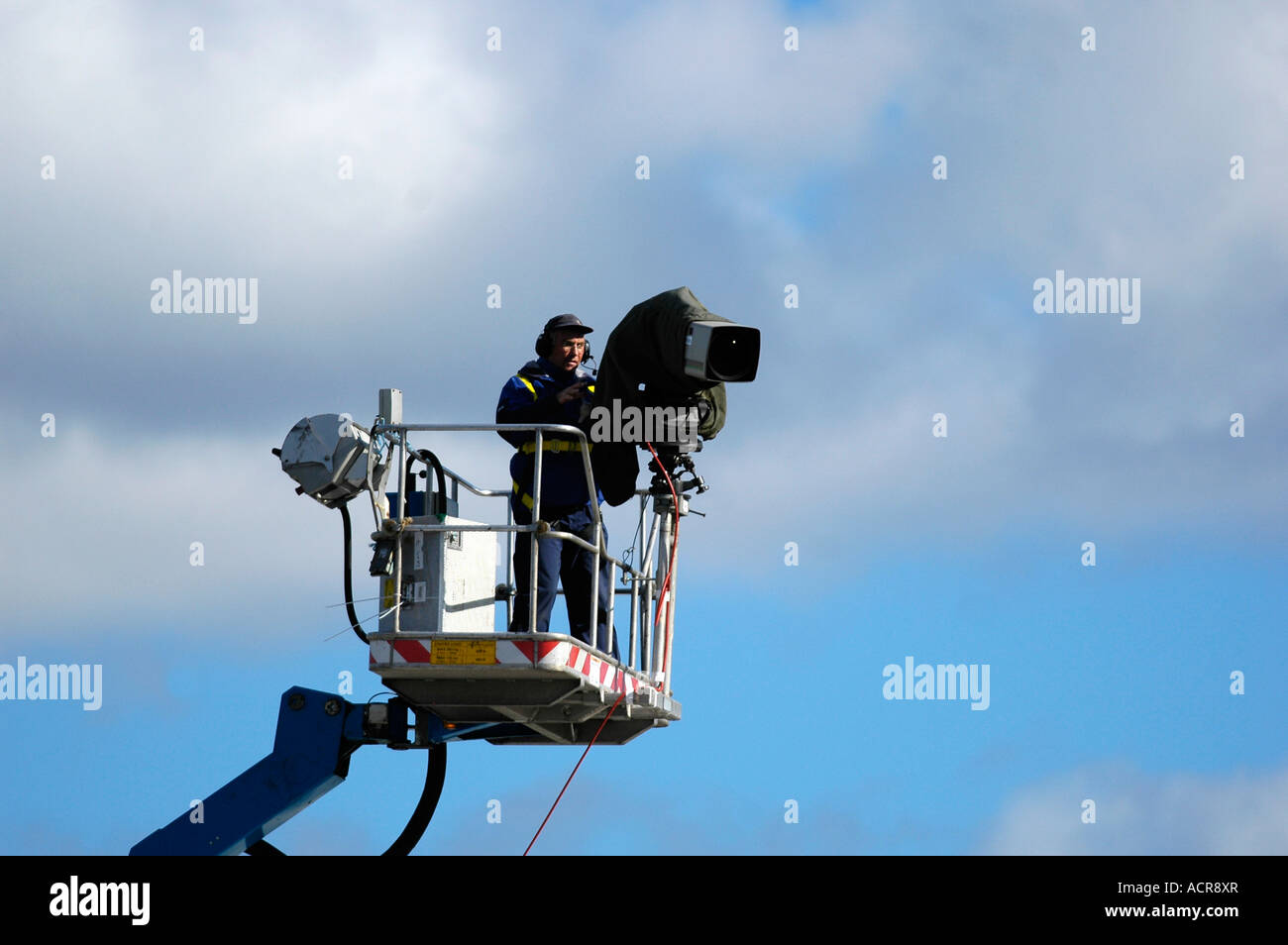 TV Cameraman filming from raised platform Stock Photo - Alamy