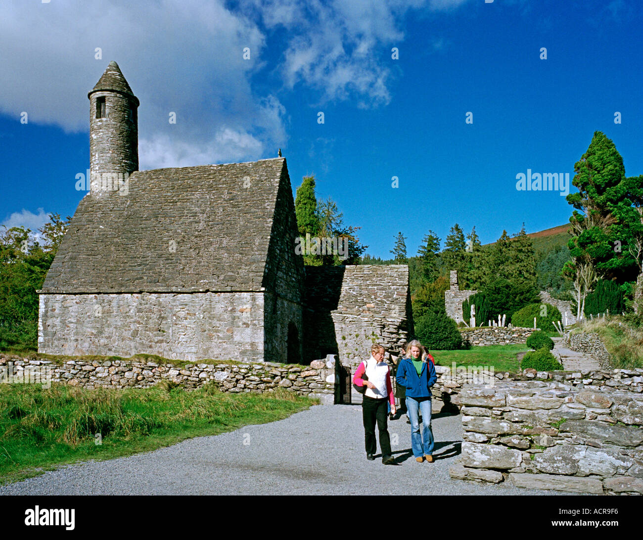 Tourists visiting the oratory called St Kevins Kitchen at the scenic ...