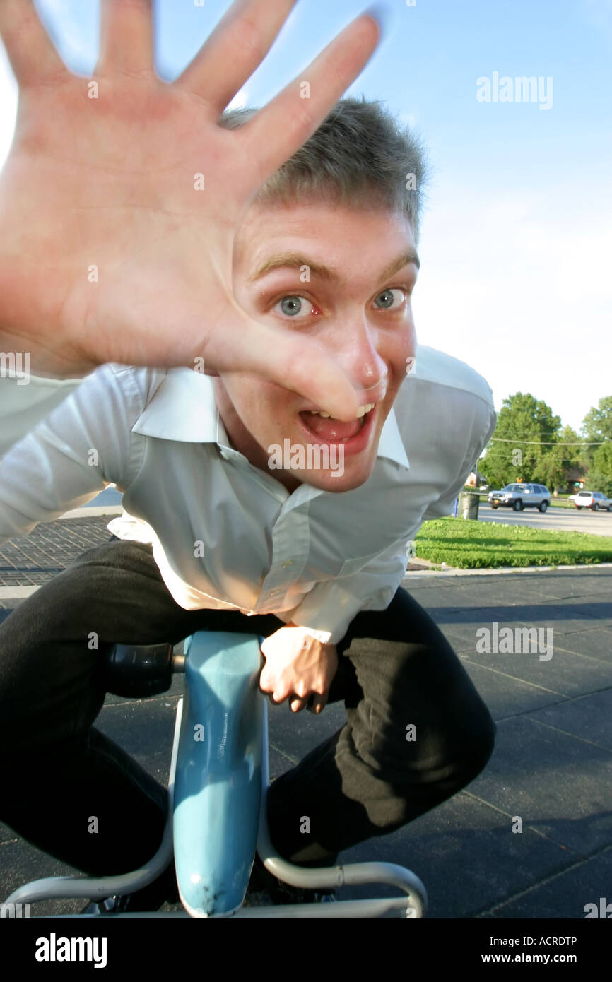 A man rides a childrens' playground implement Stock Photo - Alamy