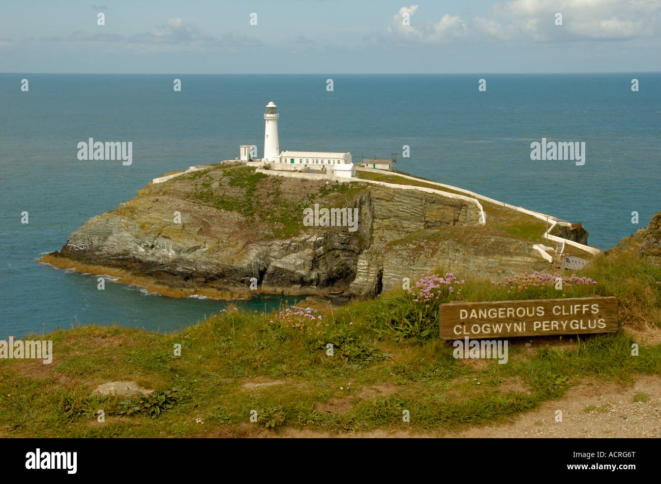 South Stack Lighthouse with sign warning of dangerous cliffs Anglesey ...