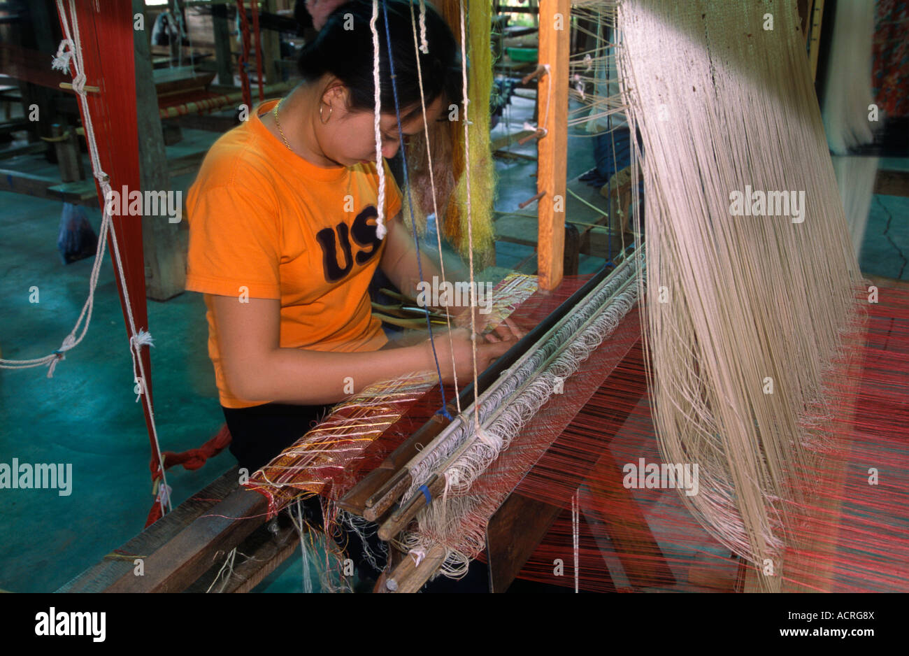 Luang Prabang Laos A weaver at the loom creating textiles with rich colourful patterns Stock ...
