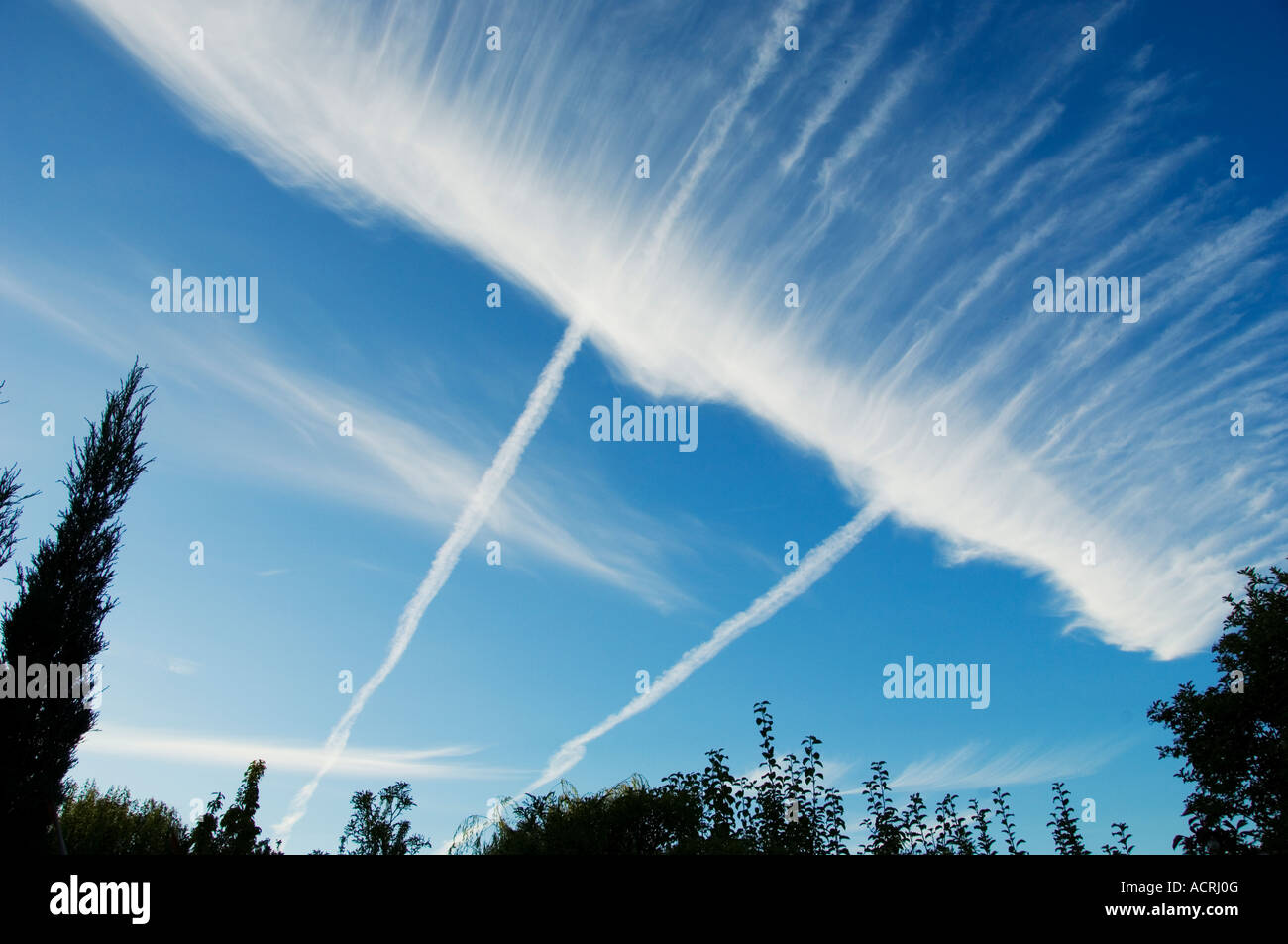 Cloud formation with vapour trails Stock Photo - Alamy