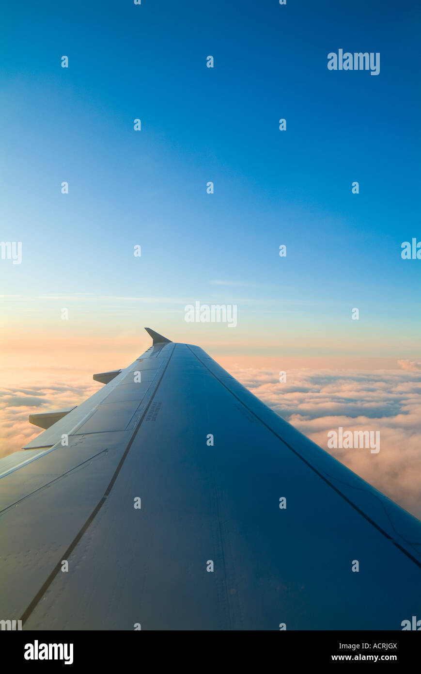 Airplane Wing At Sunset With Clouds Stock Photo - Alamy