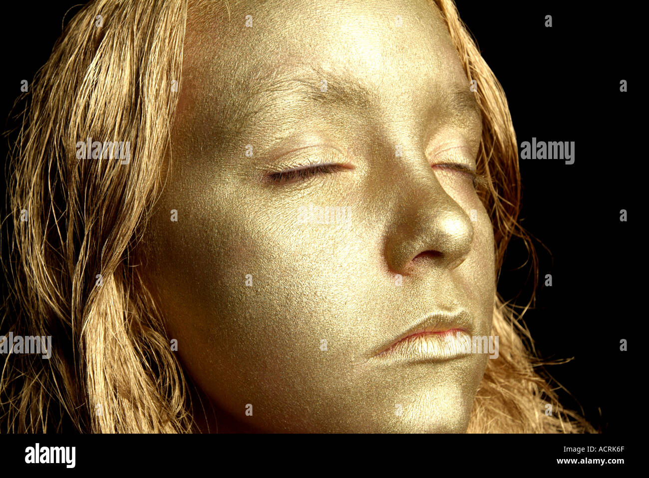 gold face girl facing sideward eye closed and gold hair Stock Photo - Alamy