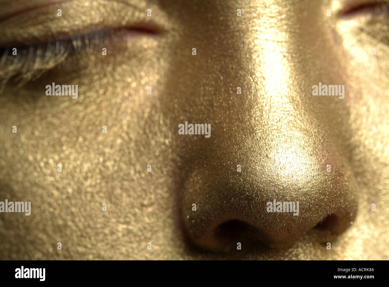 half gold face girl eye closed nose very closeup saturated Stock Photo ...