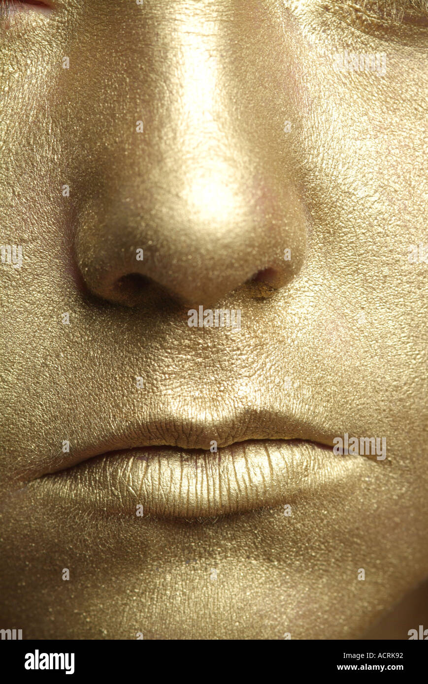 half gold face girl nose mouth very closeup saturated Stock Photo - Alamy