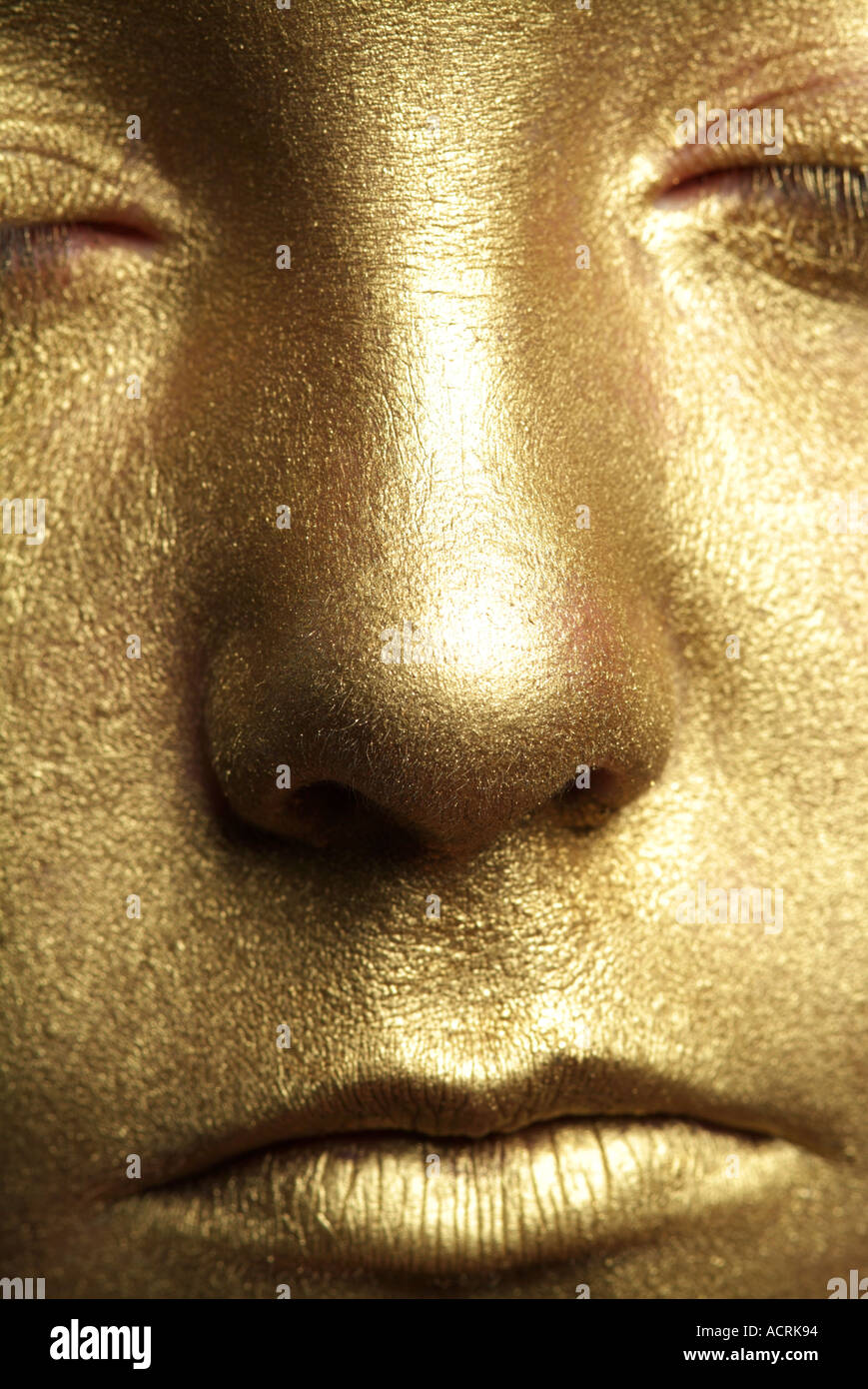 half gold face girl eye closed nose mouth very closeup saturated Stock ...