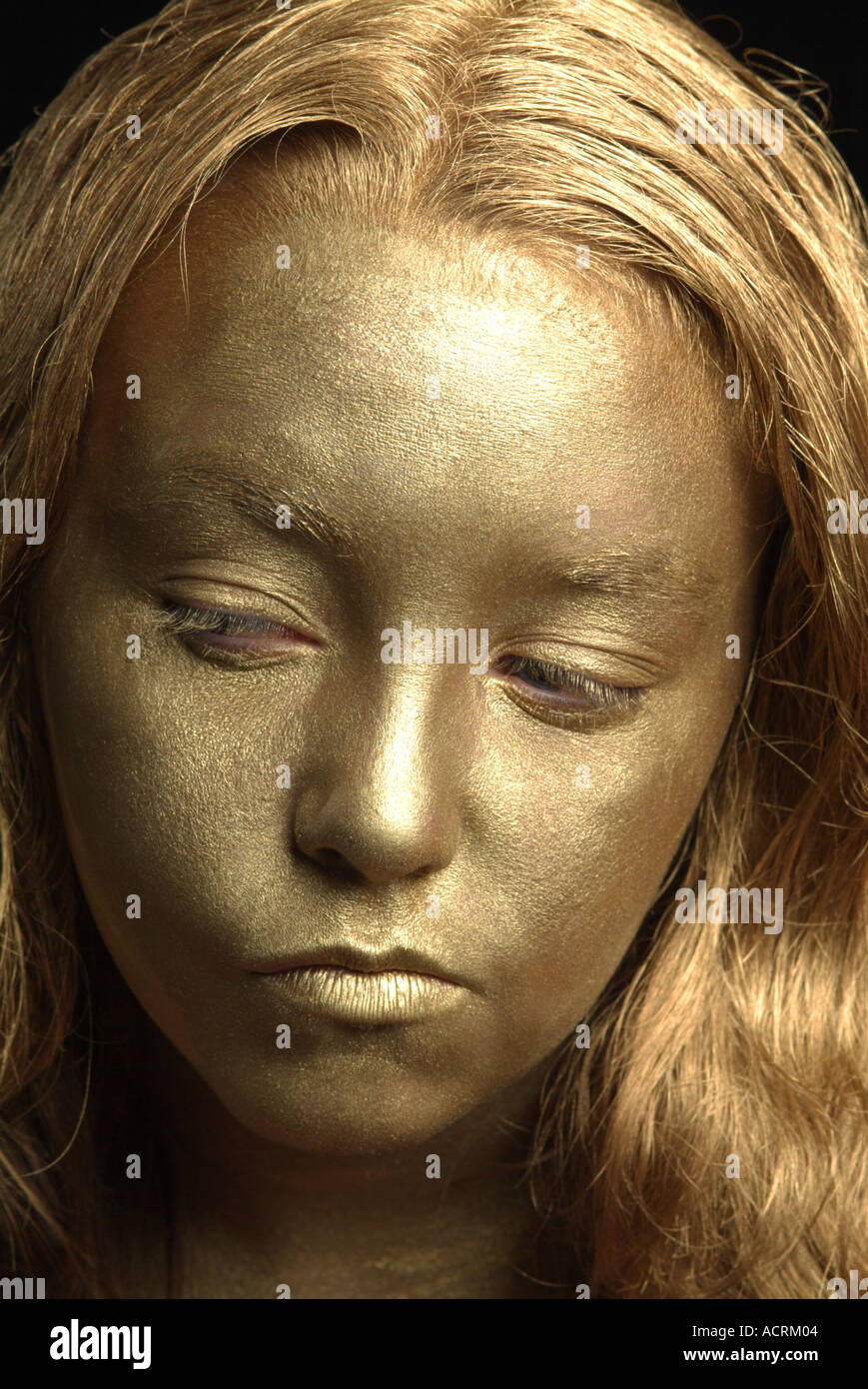 gold face girl closeup bored insolence Stock Photo - Alamy
