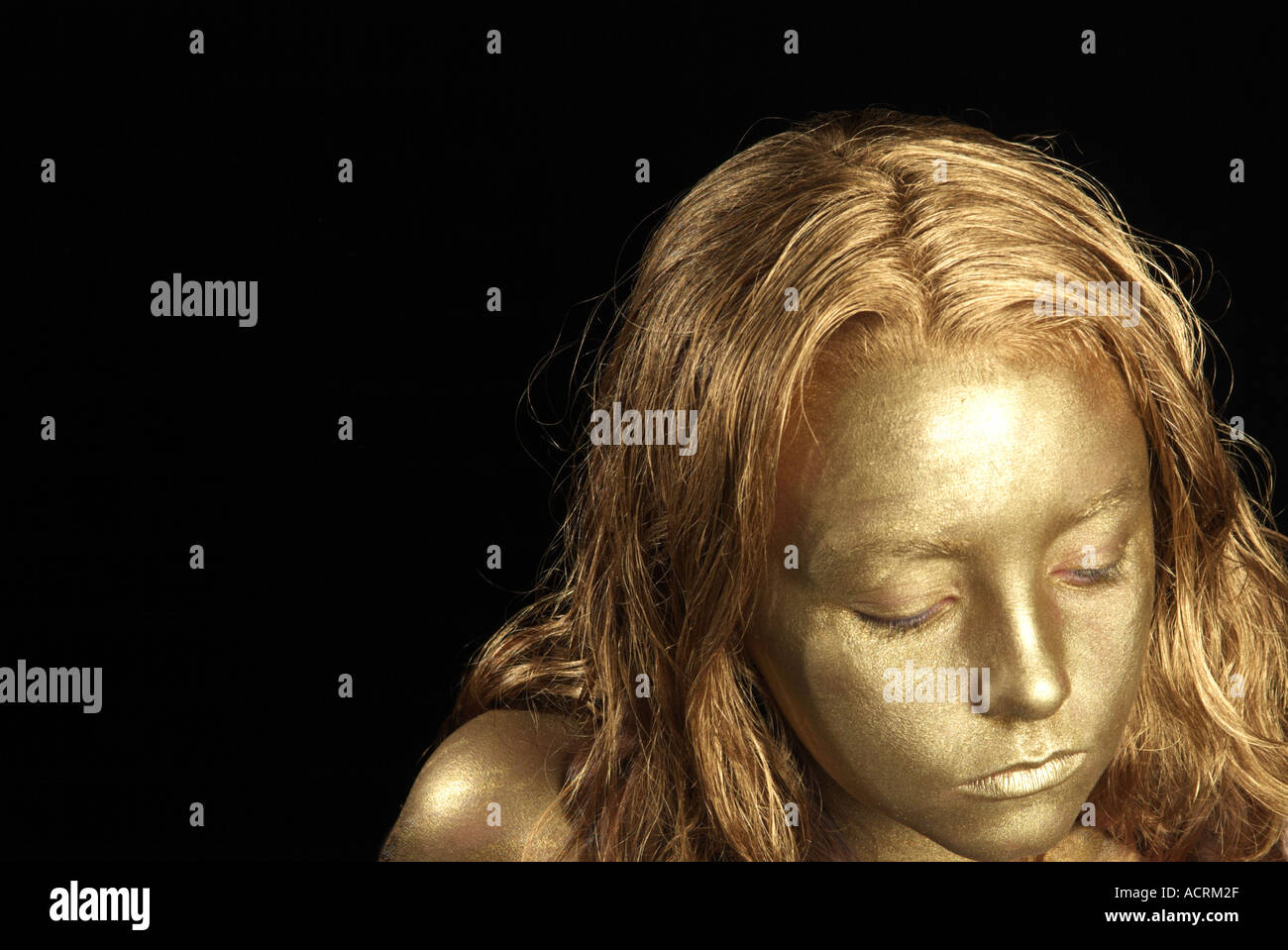 gold face girl alone in solitude Stock Photo - Alamy