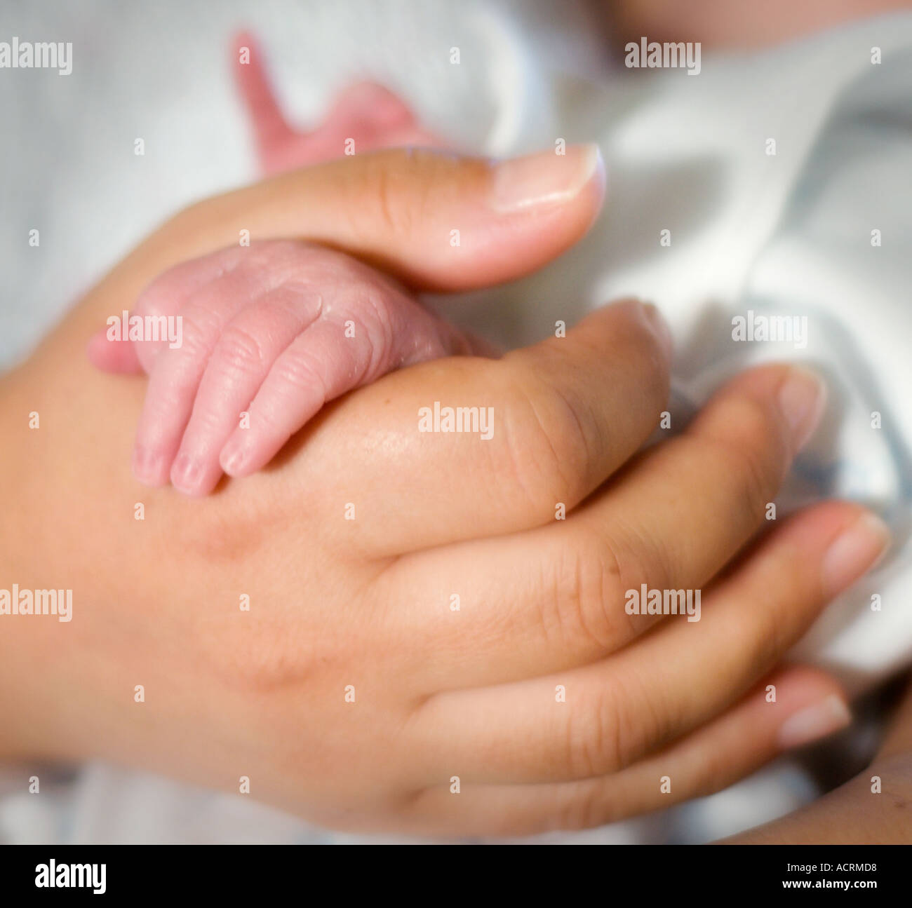Mother holding new born baby hand Stock Photo - Alamy