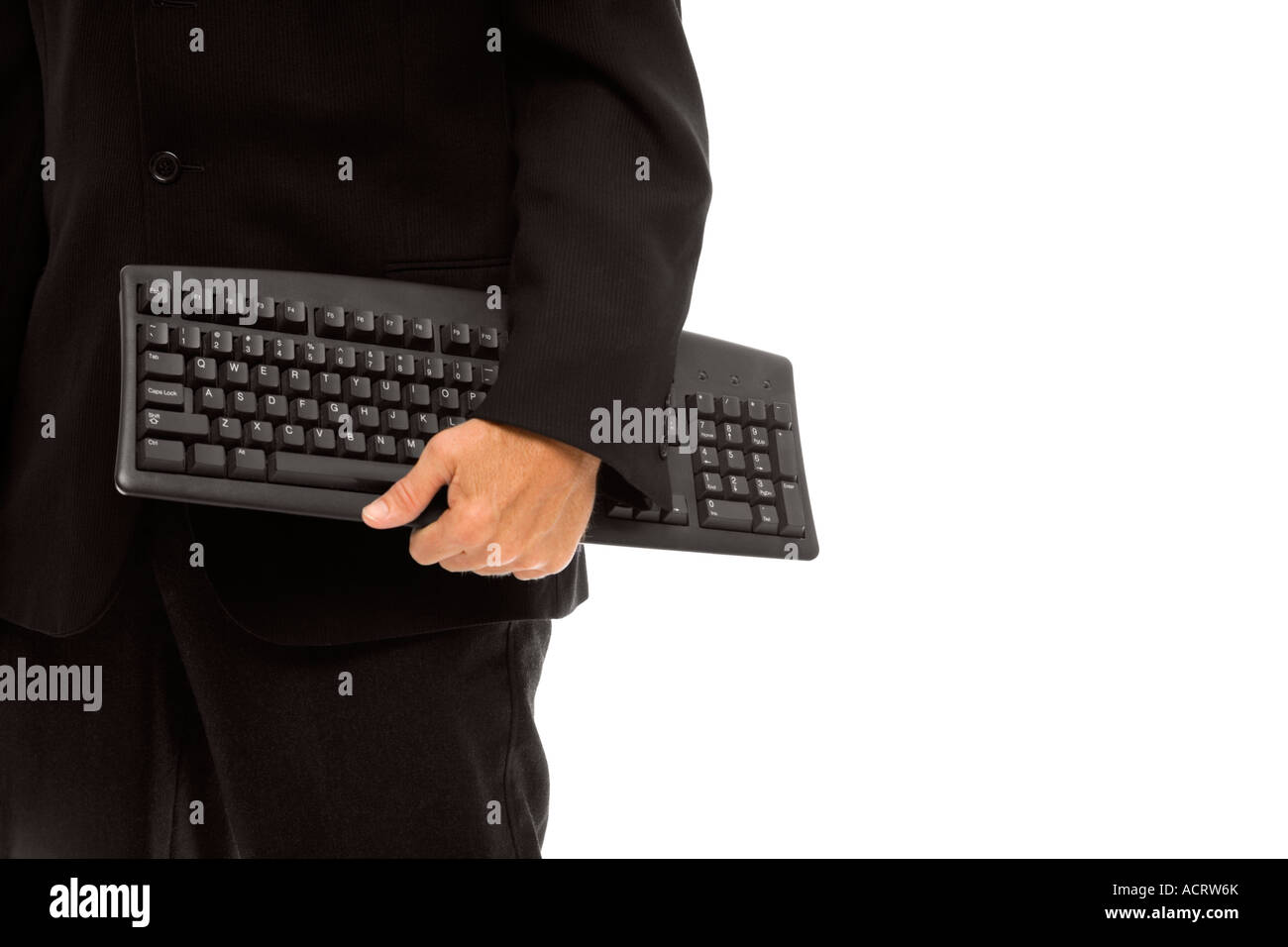 Businessman in a suit stands holding a keyboard Stock Photo - Alamy