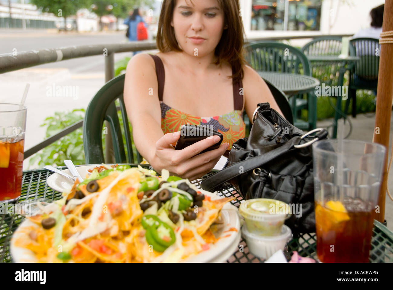 A young woman est lunch at a small outdoor cafe located in the Nob Hill ...