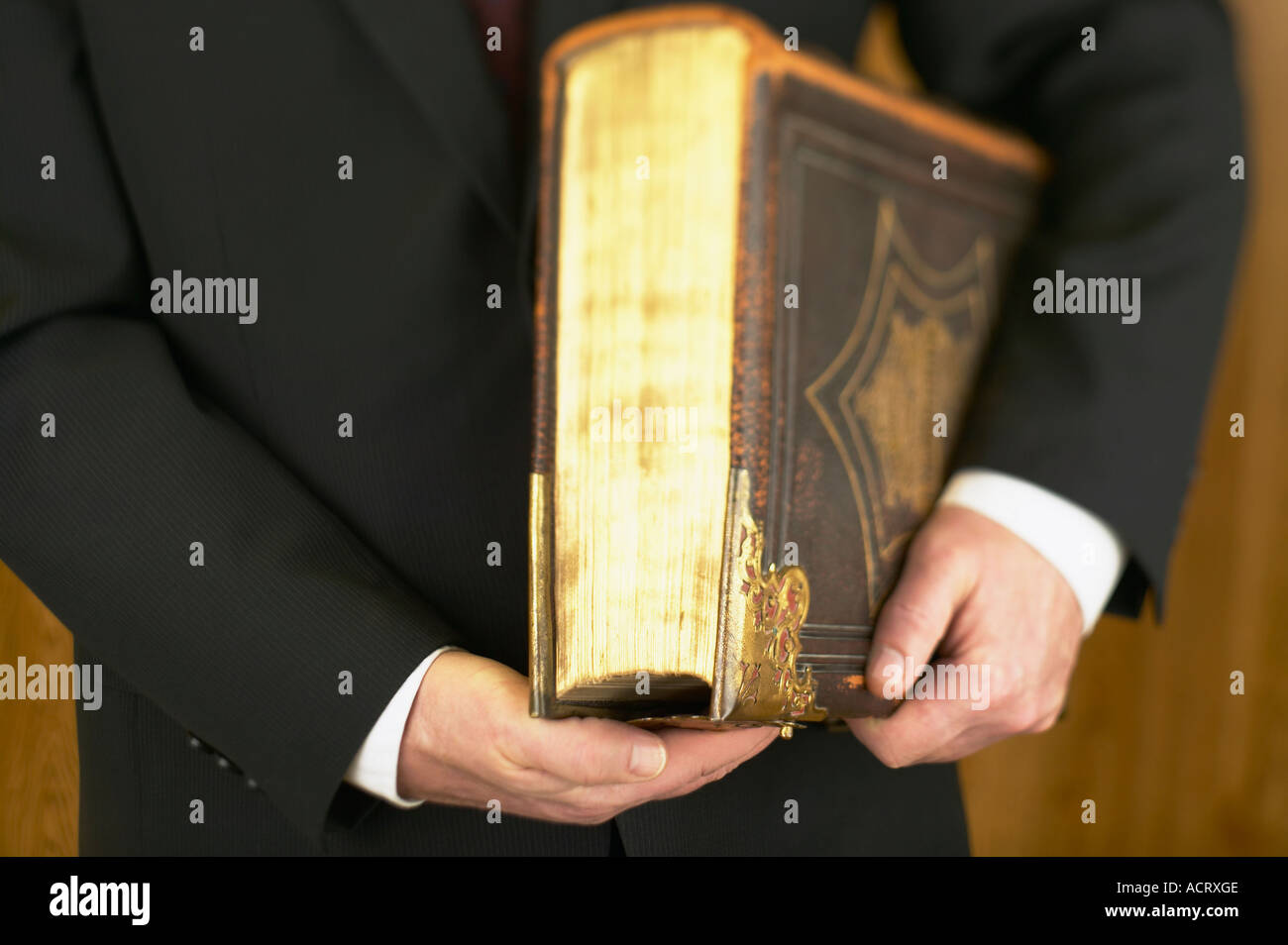 Man carrying large book Stock Photo - Alamy