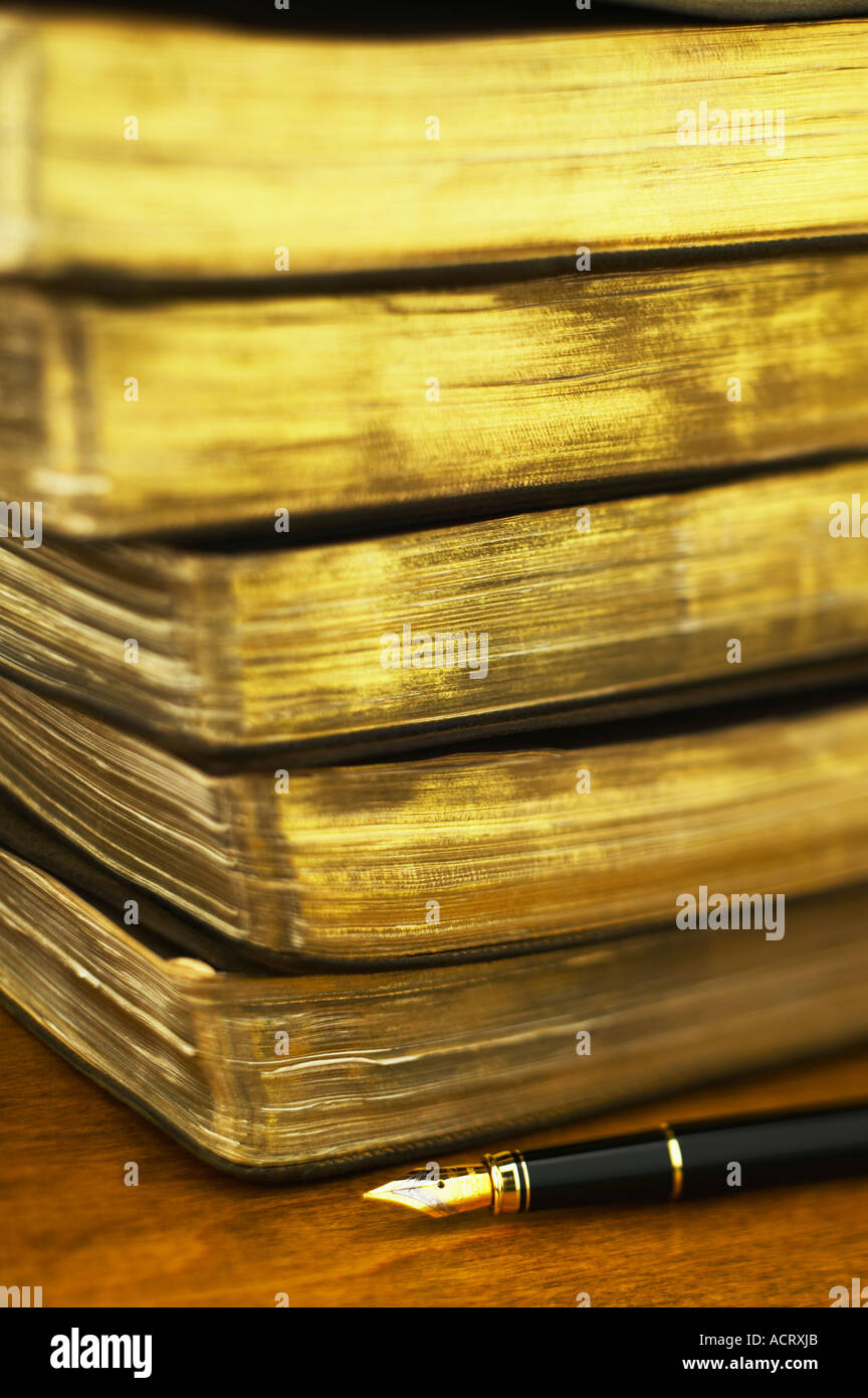 Fountain pen beside stack of old books Stock Photo - Alamy
