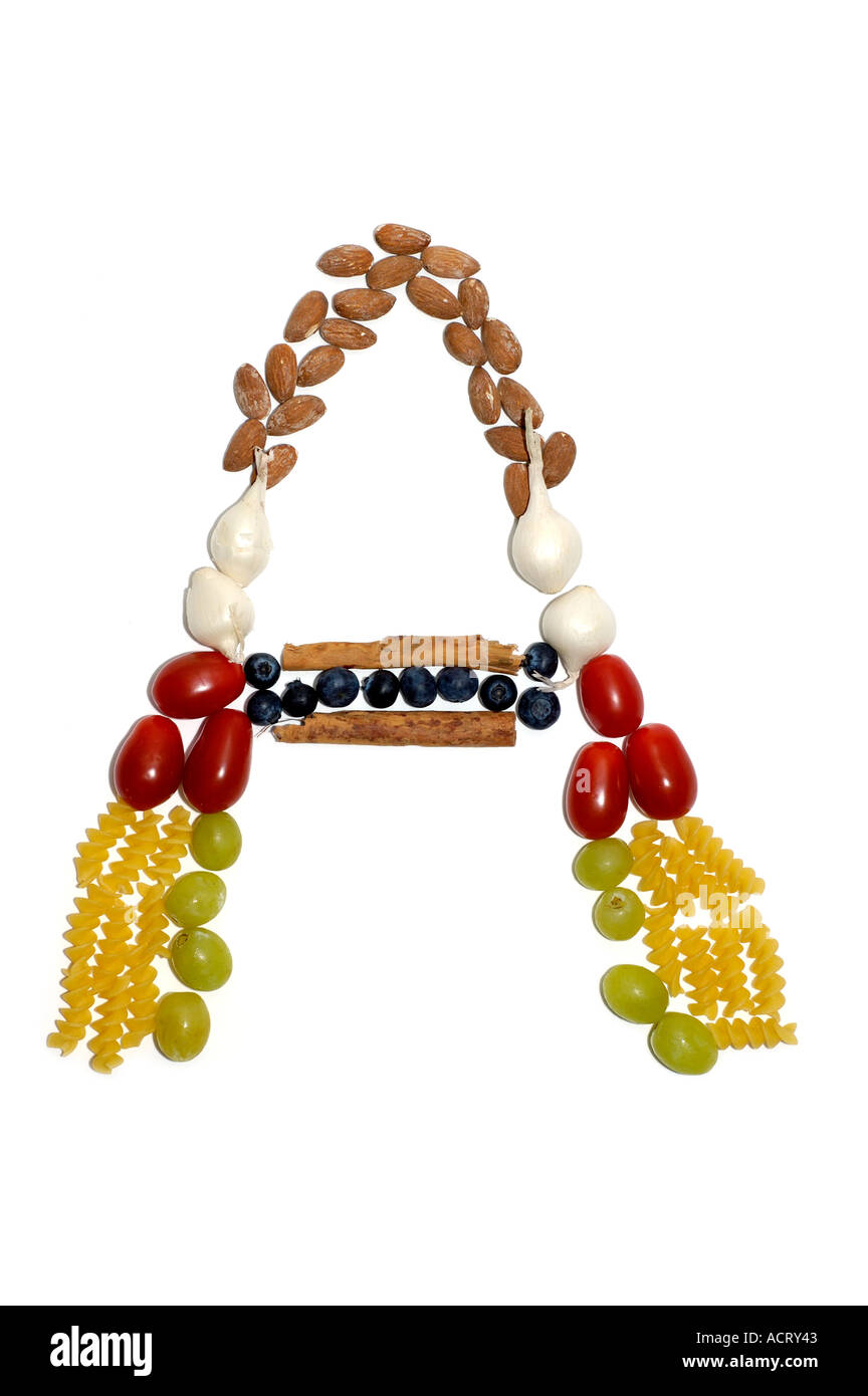 Assortment of fruits vegetables and food elements forming the letter A ...