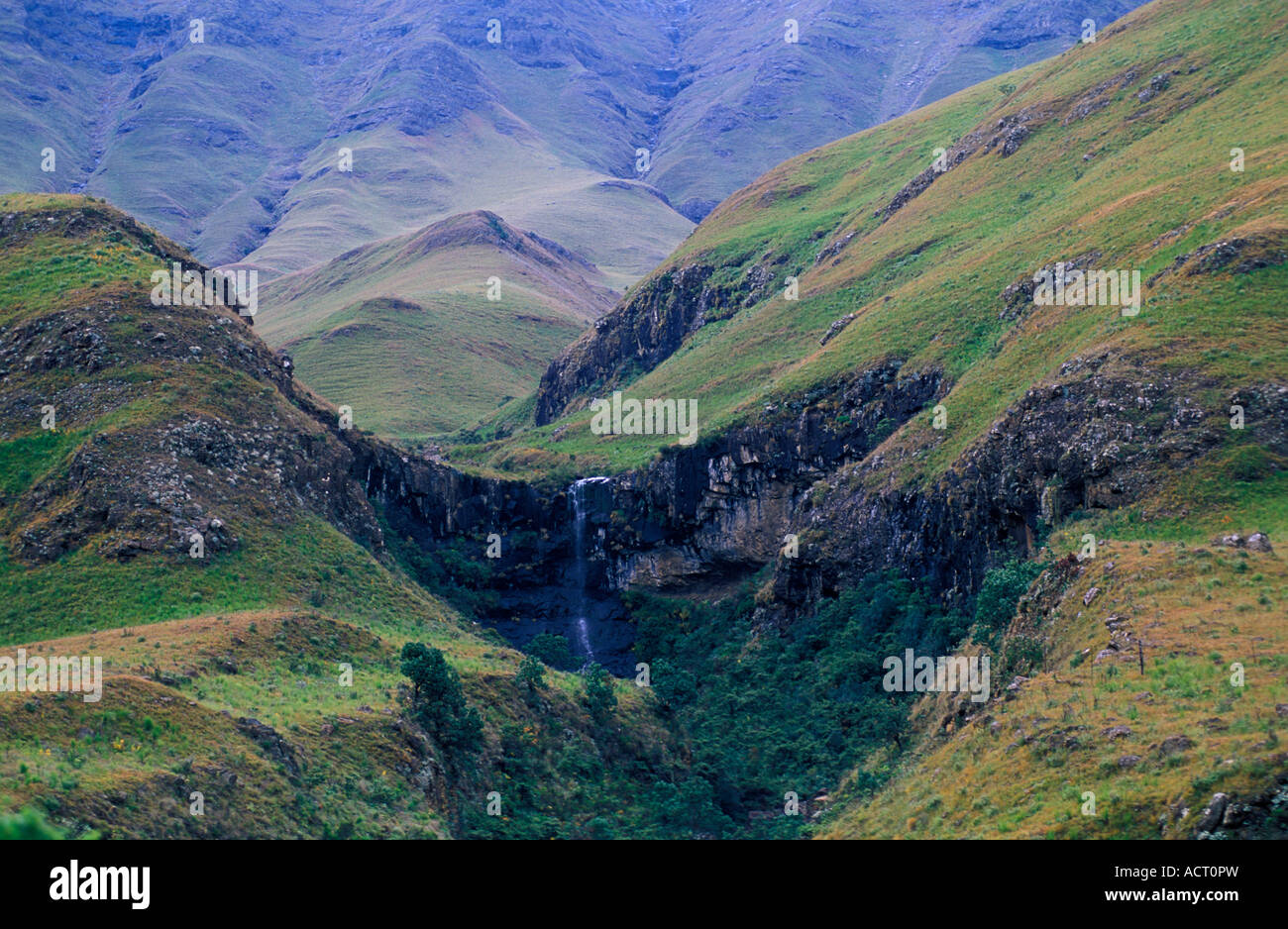 Waterfall on cave sandstone with basalt escarpment in background ...