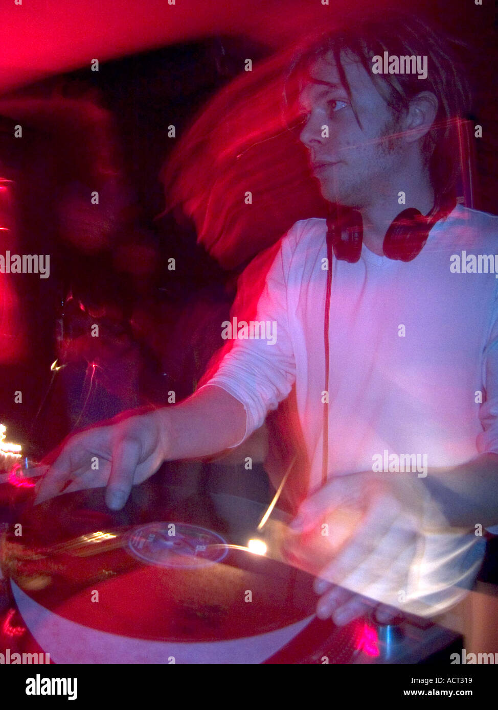 young dj on decks under a red light Stock Photo - Alamy