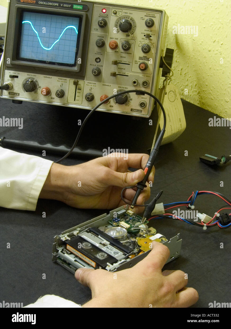 mans hands testing a computer tape drive using an oscilloscope Stock ...