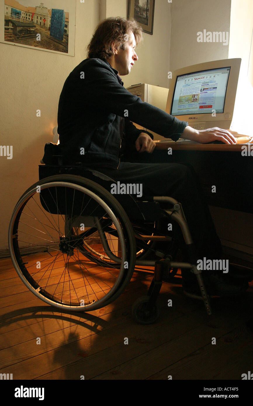 disabled young man in wheel chair working at his computer Stock Photo ...