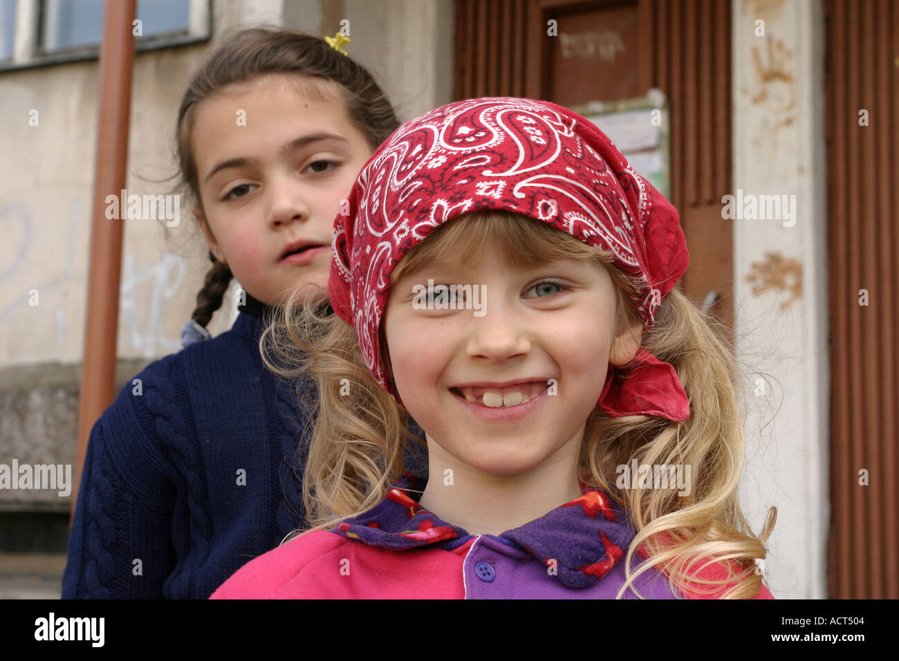 Portrait of two young girls in the street, one wearing head scarf Stock ...