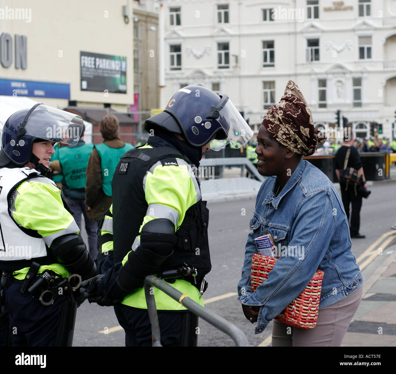 Black African woman confronting British riot police at Labour Party ...