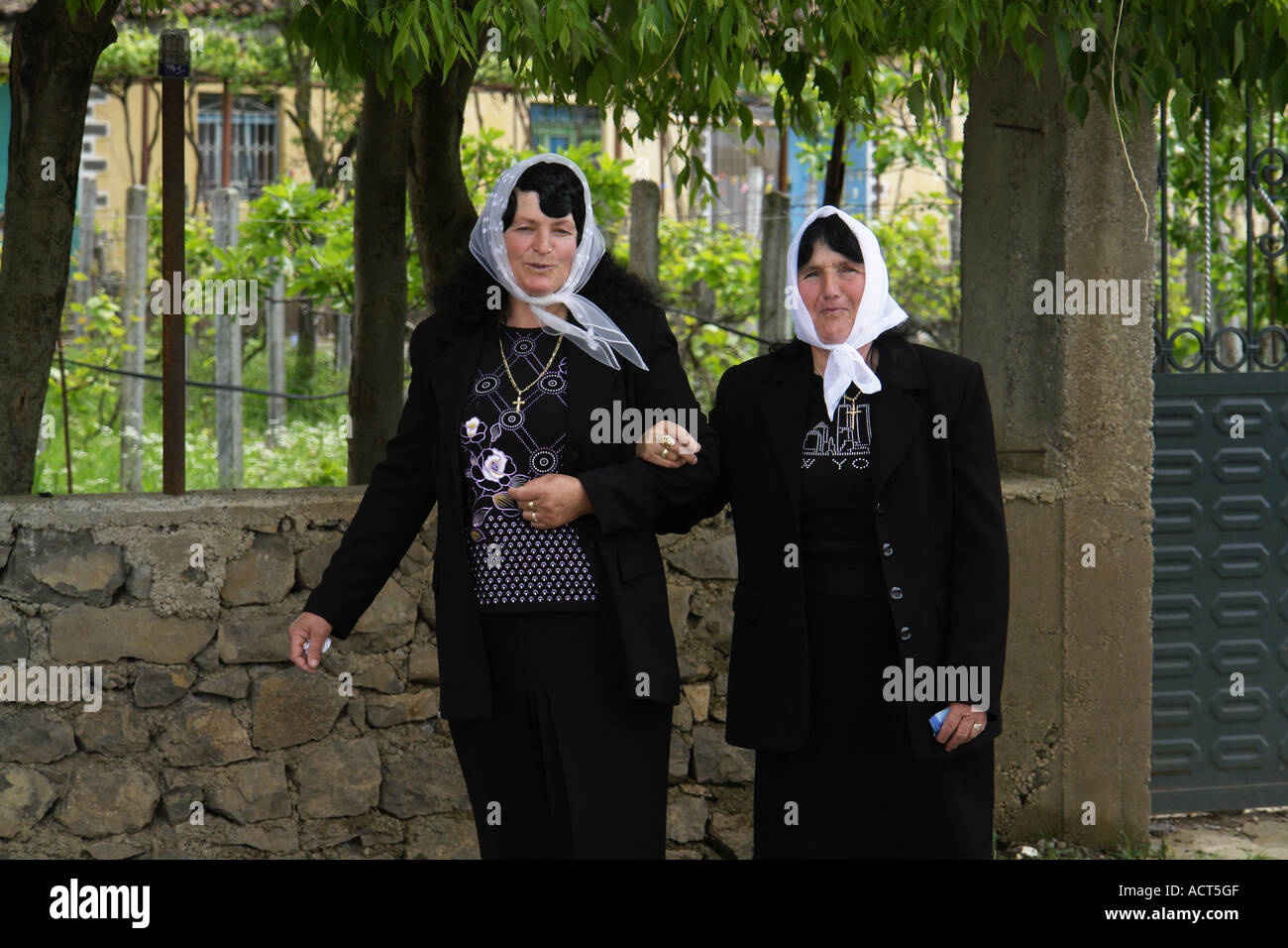 Albania women go home after sunday church Stock Photo - Alamy
