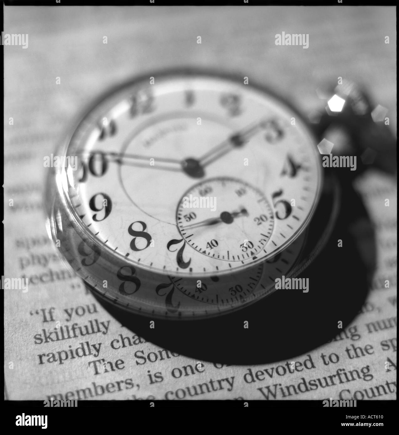 Pocketwatch on newspaper. Black and white studio photo Stock Photo - Alamy