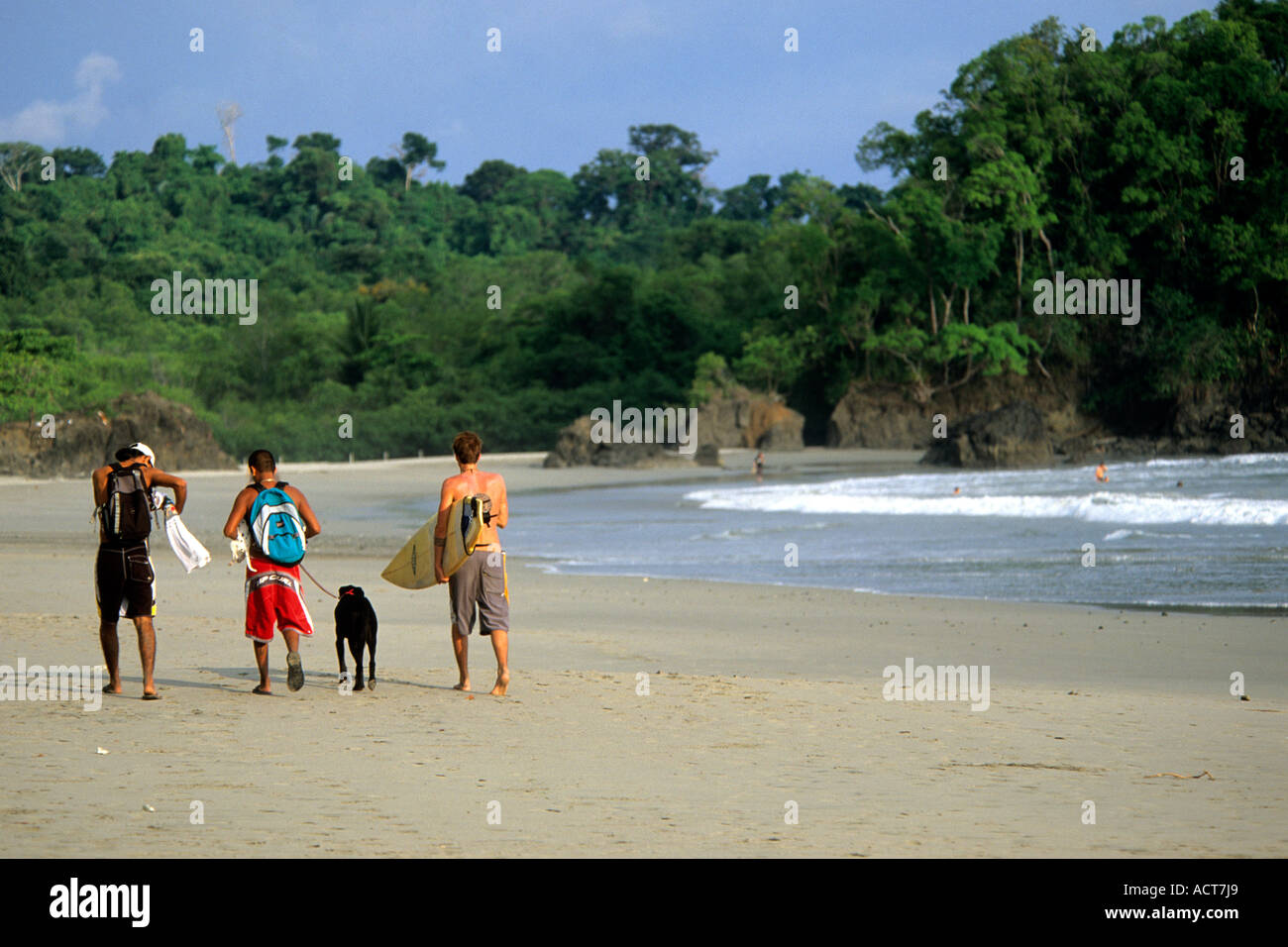 Surfers and dog on beach at Manuel Antonio National Park, Quepos Costa ...