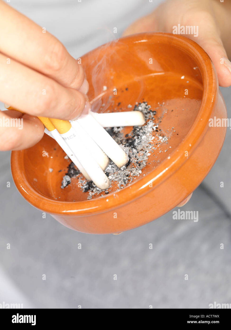 Stubbing out cigarettes hi-res stock photography and images - Alamy