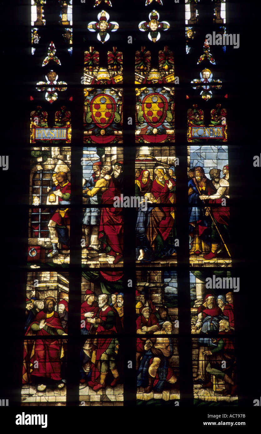 Brightly colored stained glass window depicting a religious story ...