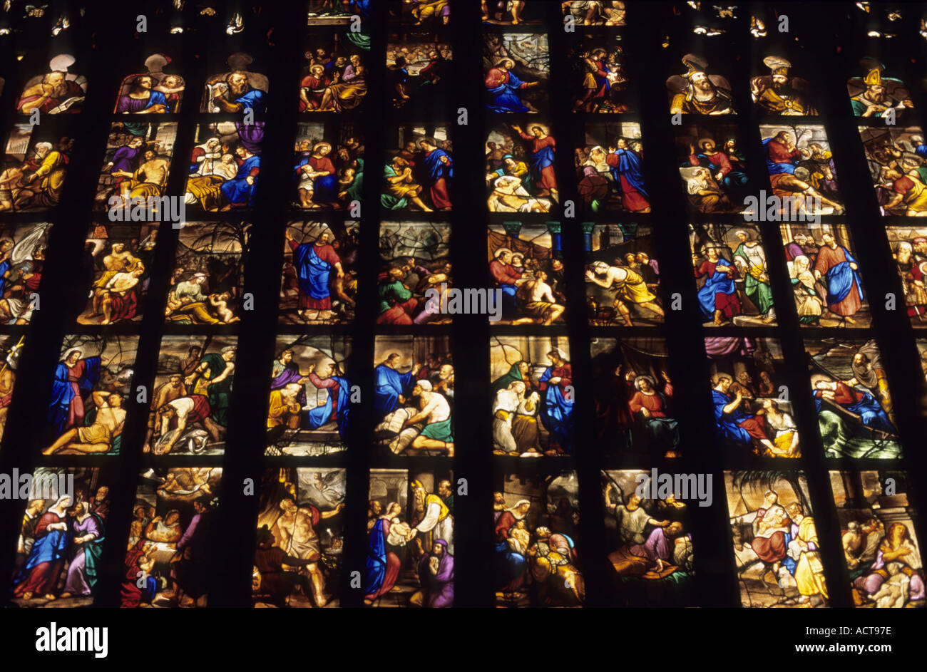 Brightly colored stained glass window depicting a religious story ...