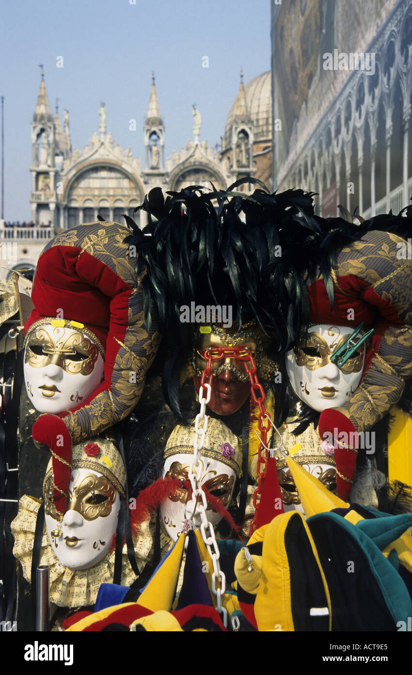 Person surrounded by elaborate masks for sale on St Mark's Basilica ...