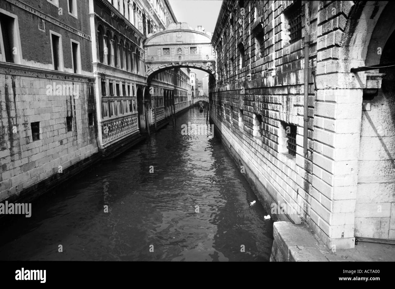 Empty canal walled by building exteriors in Venice, Italy Stock Photo ...