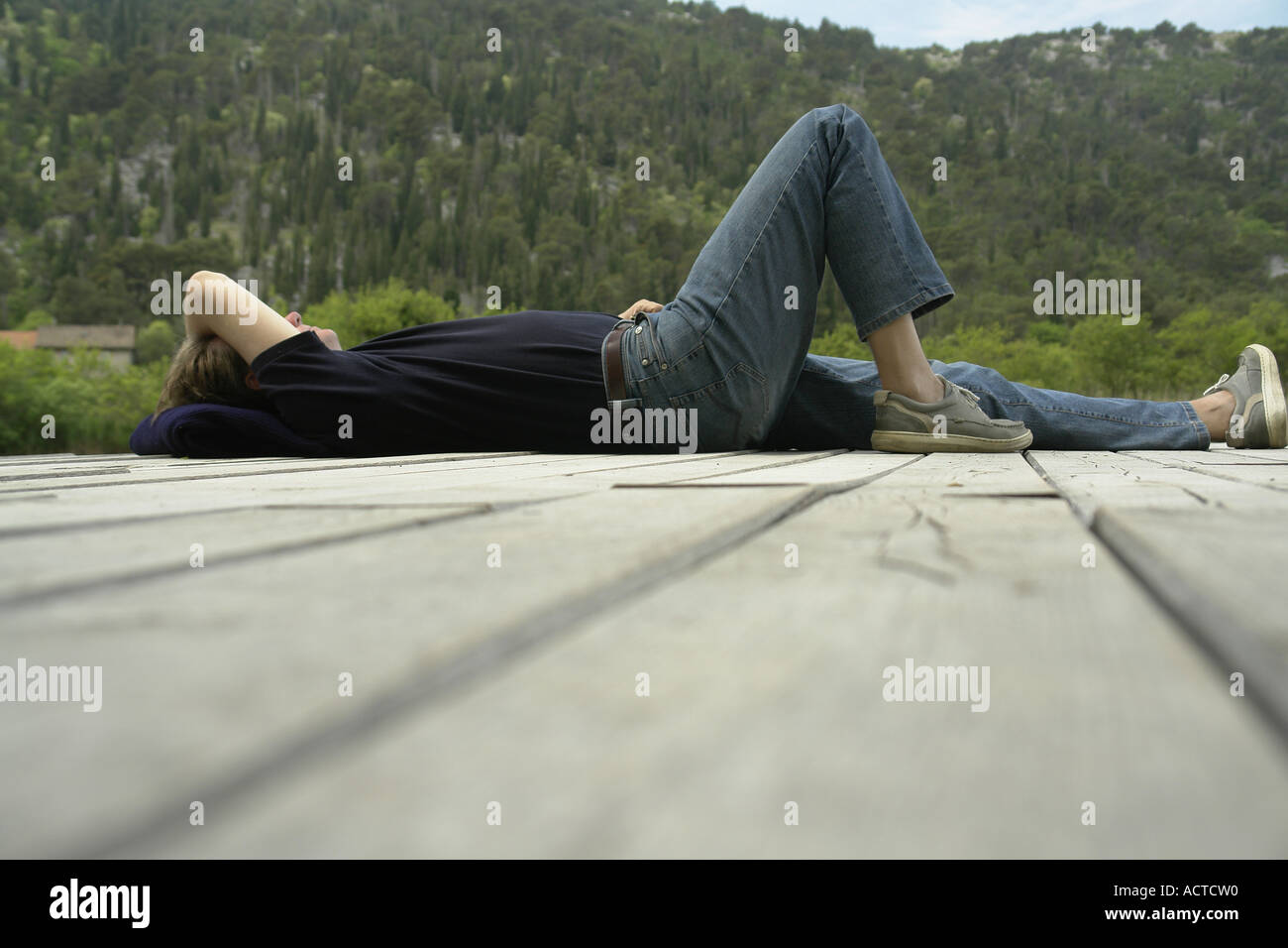 Man lay down on wooden floor Stock Photo - Alamy