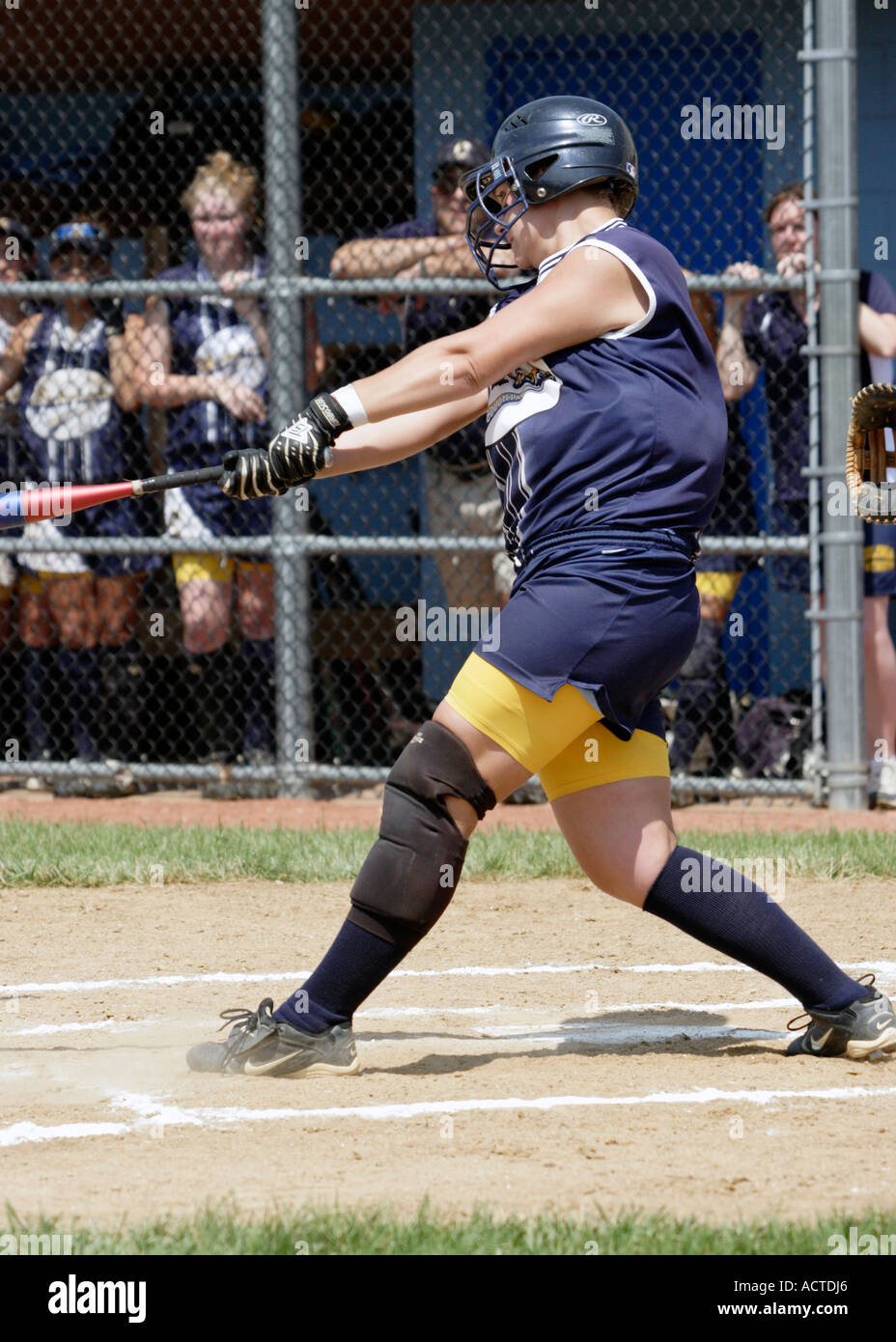 Softball player takes a swing Stock Photo - Alamy
