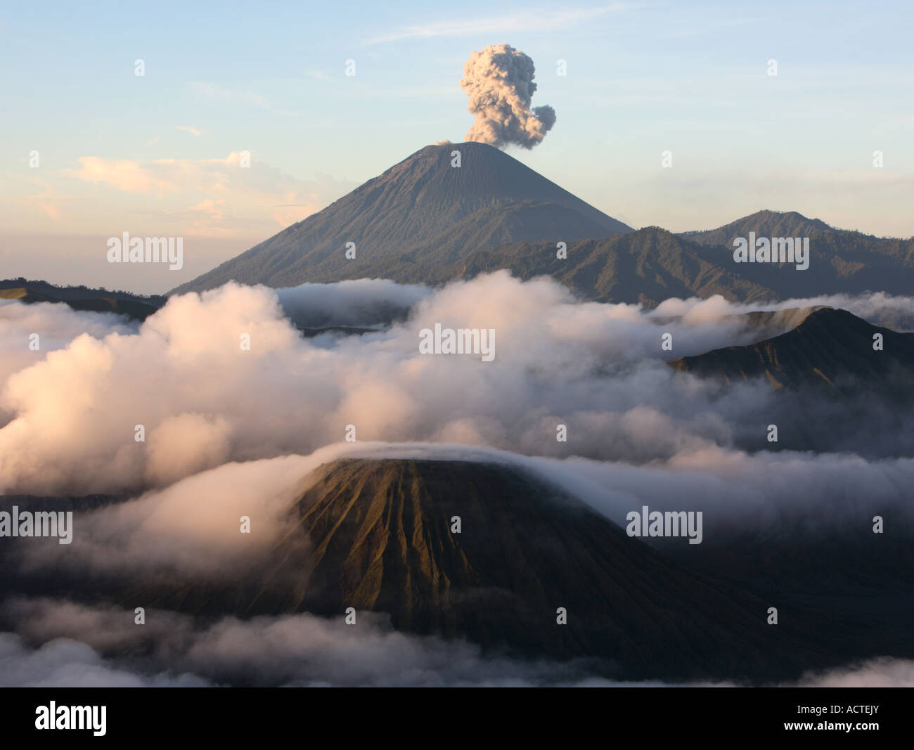 The volcano Gunung Penanjakan bellows smoke over the landscape of the ...
