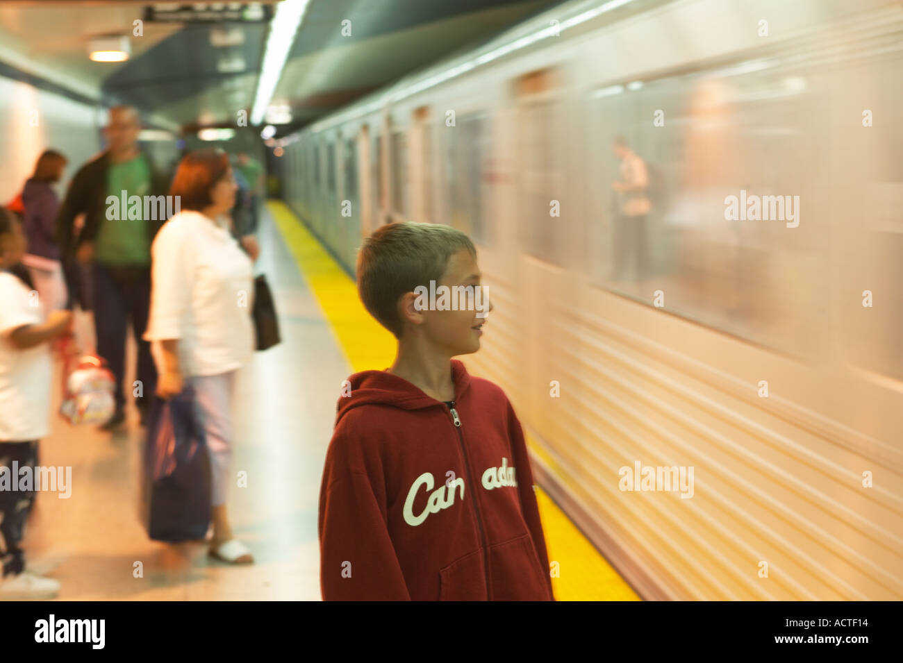 Boy standing next to speeding subway train Stock Photo - Alamy